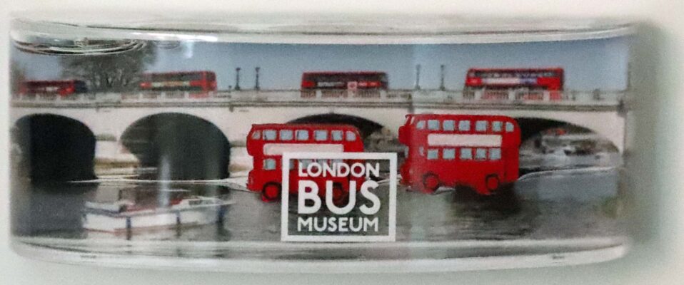 Liquid-filled Fridge Magnet with floating buses across a background of ...